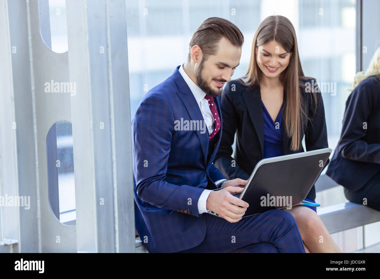 Business people having a break, sitting with laptop and smiling Stock ...