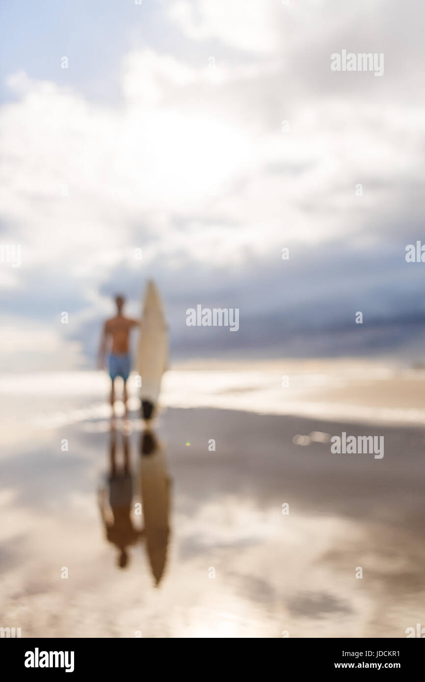 Out of focus, blurry image of handsome man with surfing surf board ...