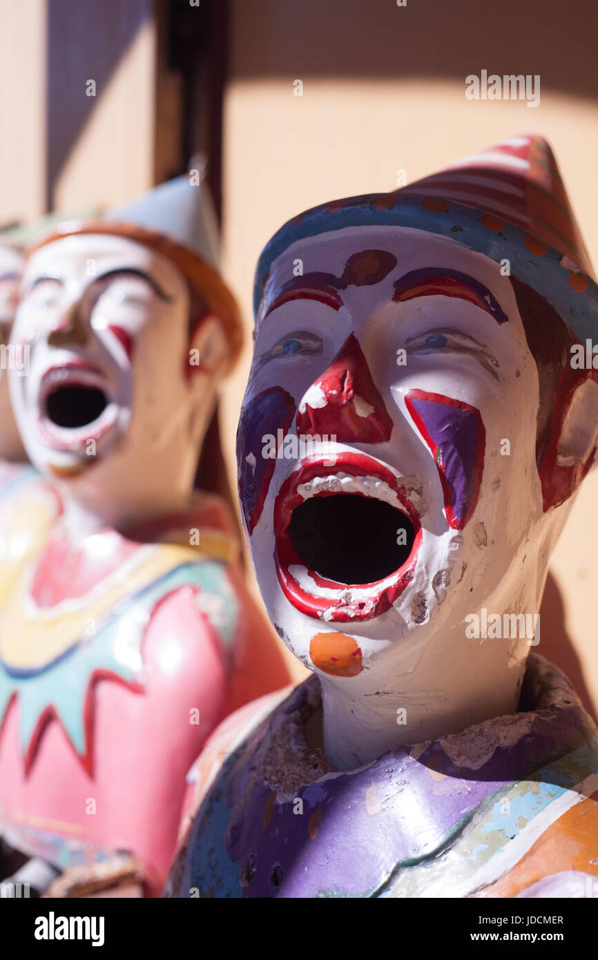Clown figures with open mouths from a fairground Stock Photo - Alamy