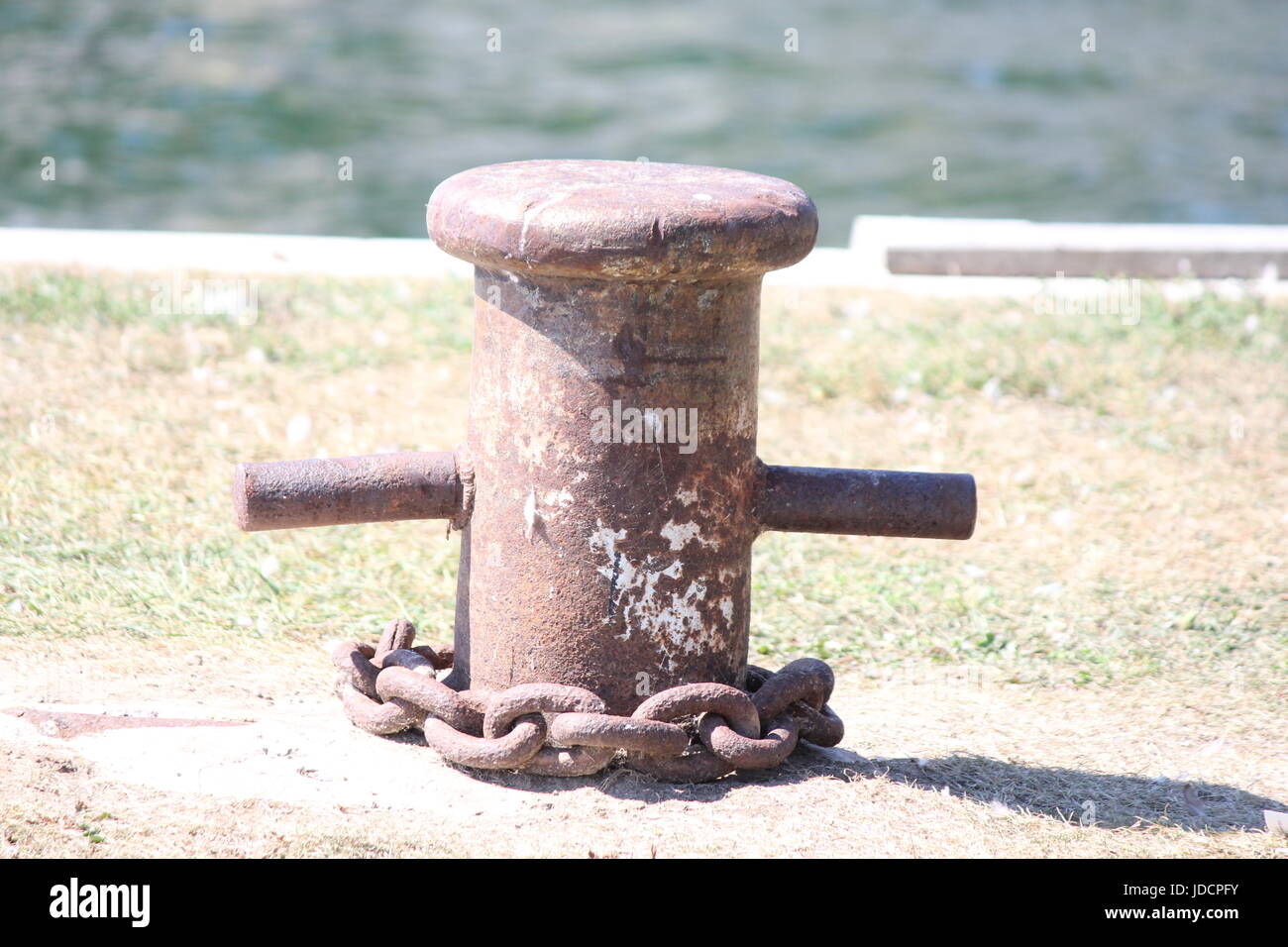 Old rustic metal mooring post attached to an unused boat docking pier ...