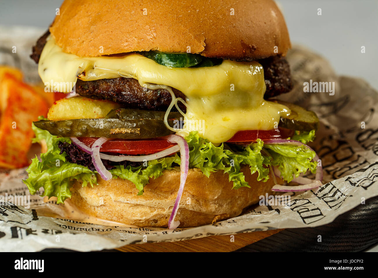 Craft beef burger and french fries on wooden table Stock Photo - Alamy