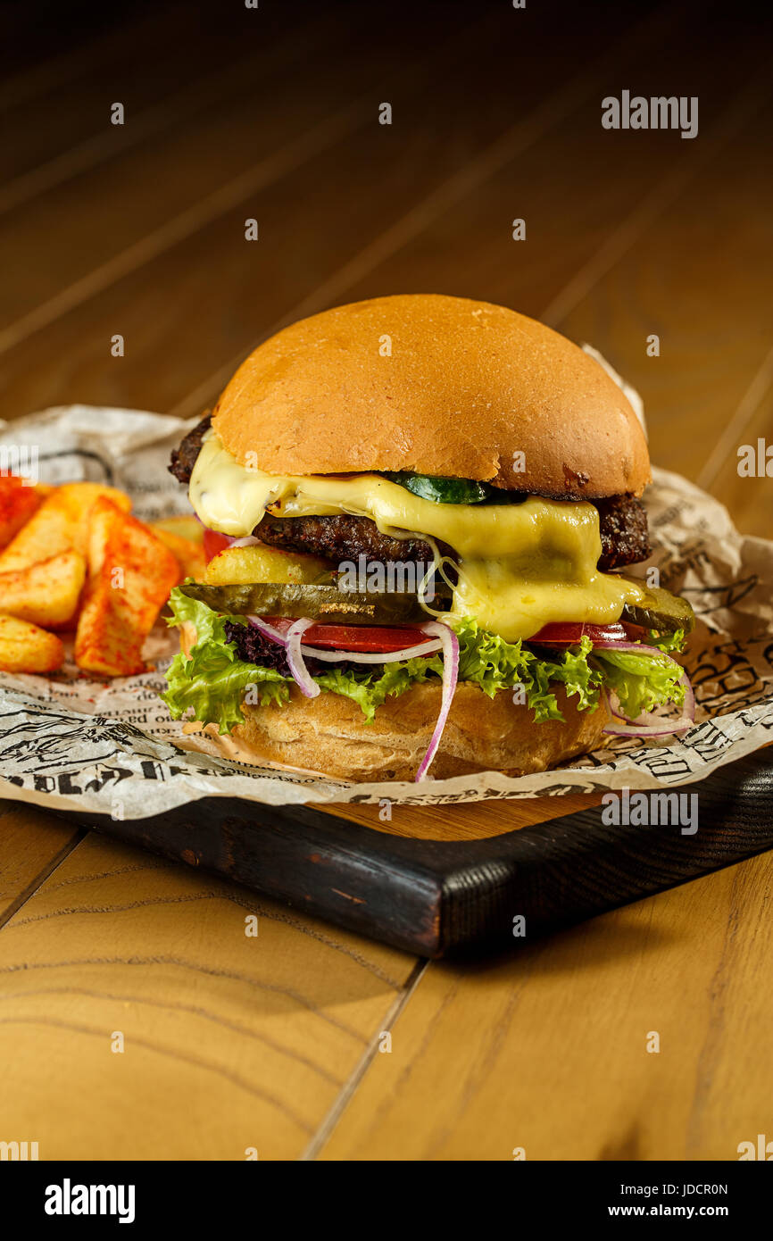 Craft beef burger and french fries on wooden table Stock Photo - Alamy