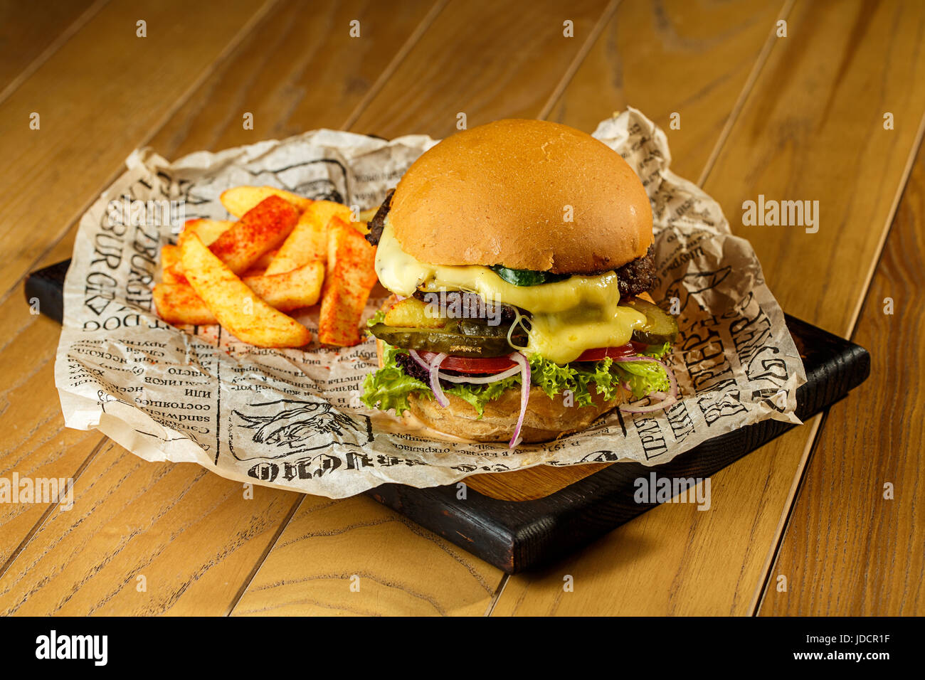 Craft beef burger and french fries on wooden table Stock Photo - Alamy