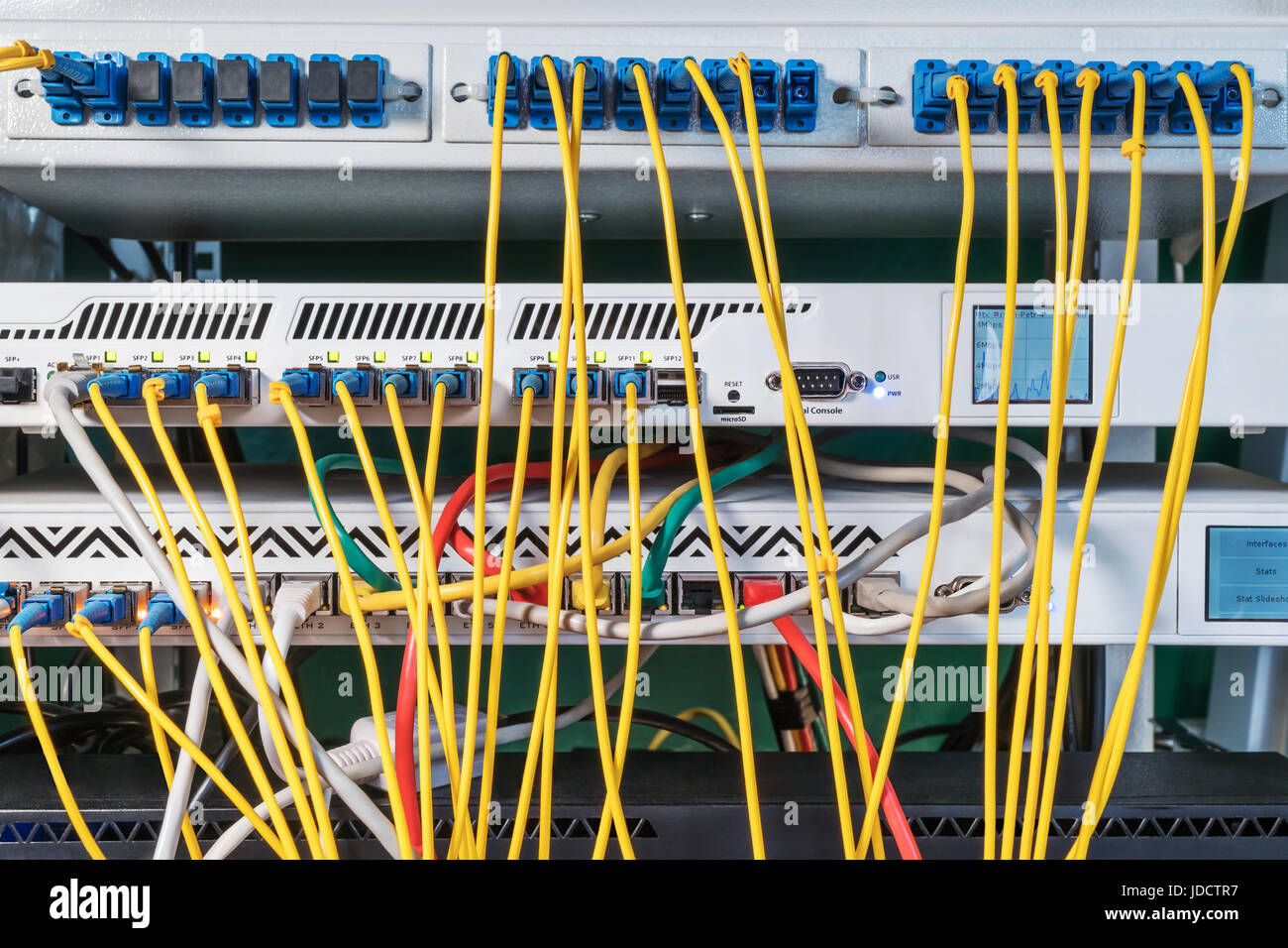 Rack with a lot of routers and wires connected to them Stock Photo - Alamy