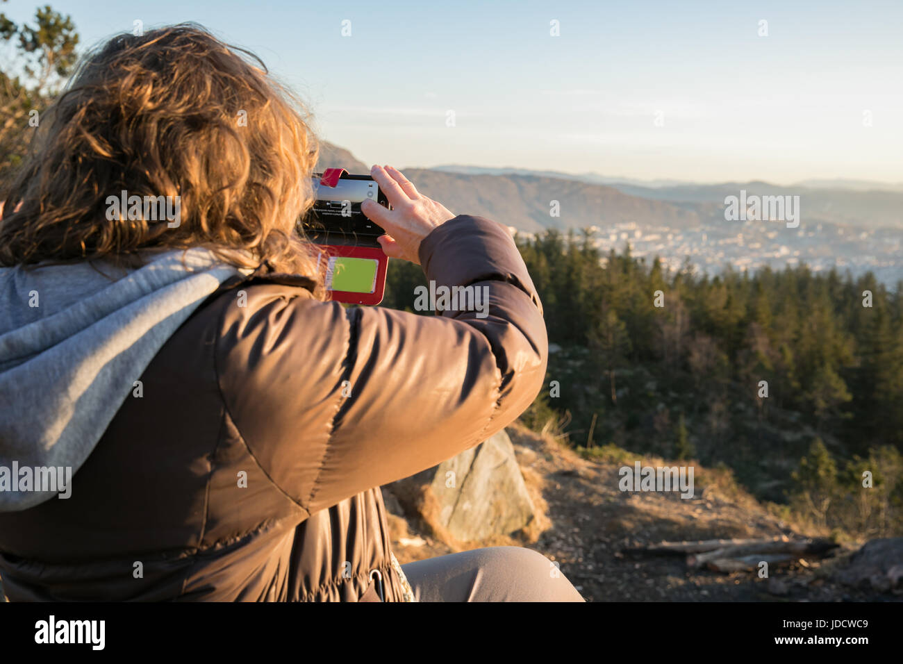 Woman photographer capturing mountain hi-res stock photography and ...