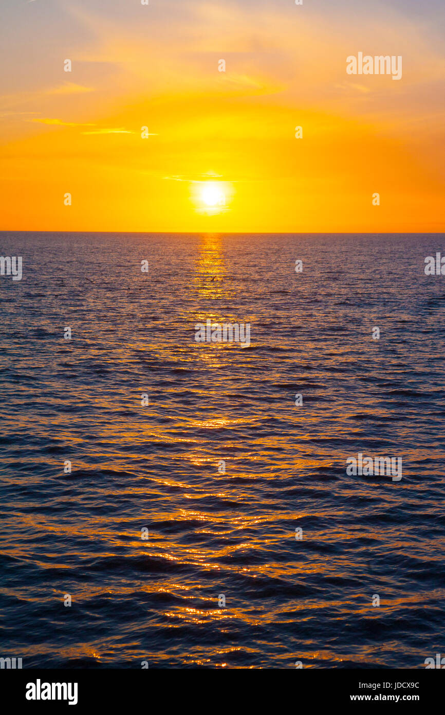 Golden sunset over water, Ocean, sea Stock Photo - Alamy