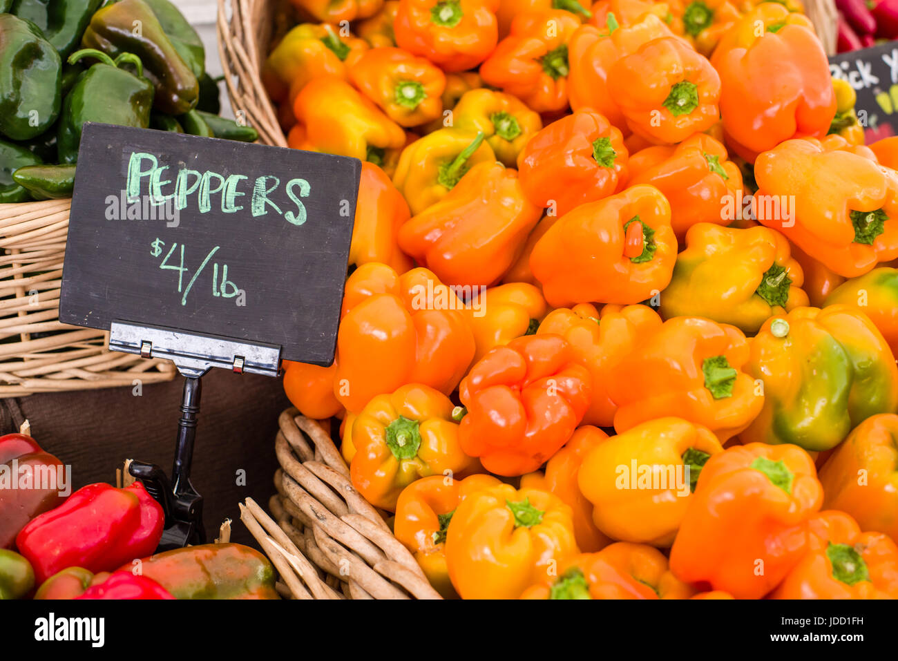 Display of fresh orange peppers at the farmers market Stock Photo - Alamy