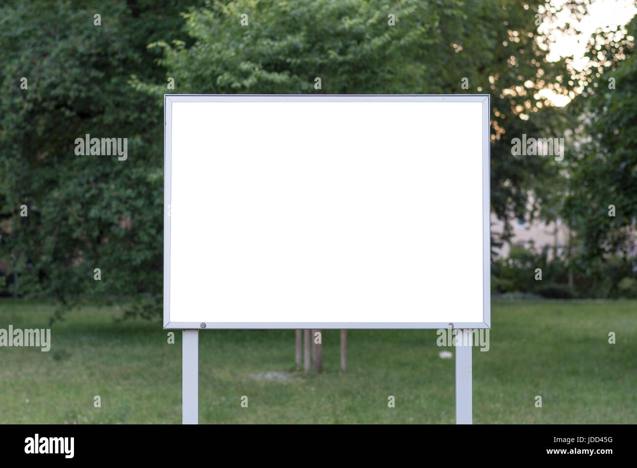 Blank ad space sign infront of trees in a park Stock Photo - Alamy