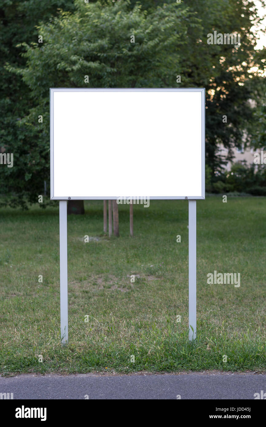 Blank ad space sign infront of trees in a park Stock Photo - Alamy