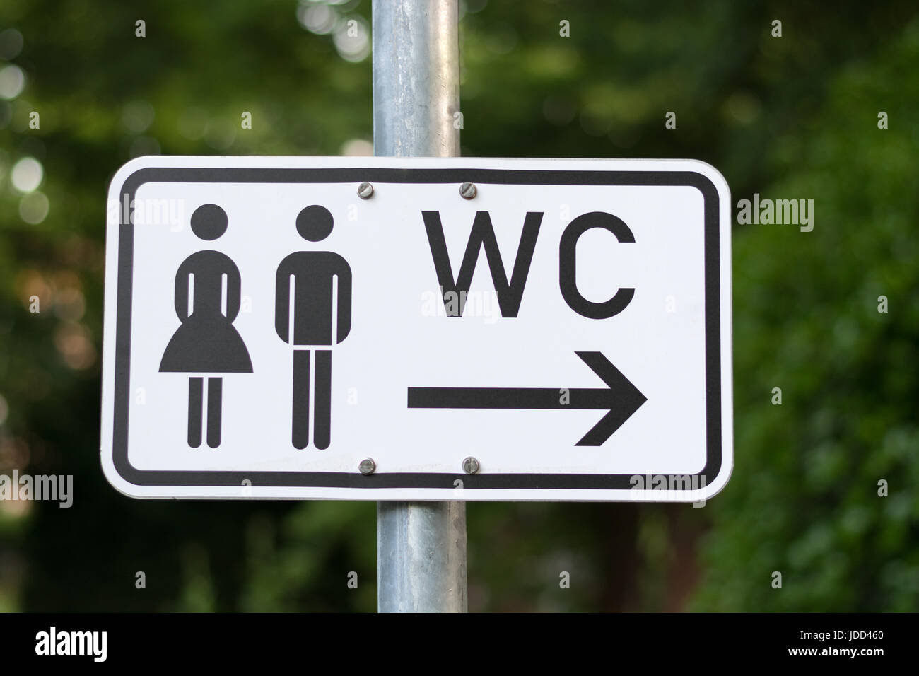 A WC sign isolated on a pole in a park Stock Photo - Alamy
