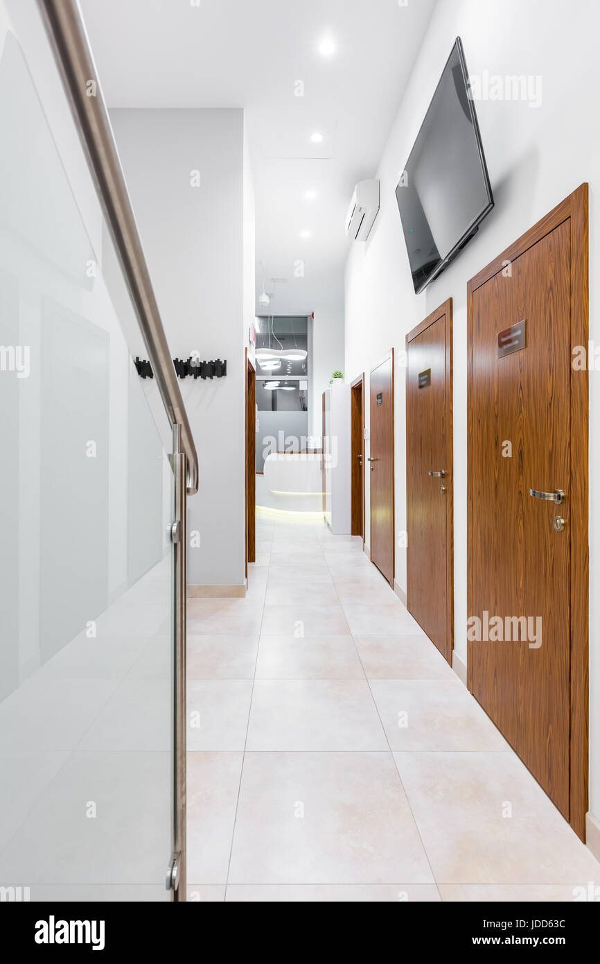 Modern interior of private clinic with staircase, screen and wooden ...