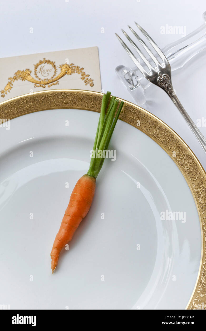 Carrot on a plate and menu on a luxury table set Stock Photo - Alamy