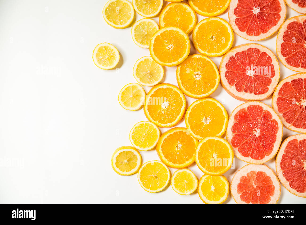 Gradient citrus slices - grapefruit, orange and lemon, placed on white ...