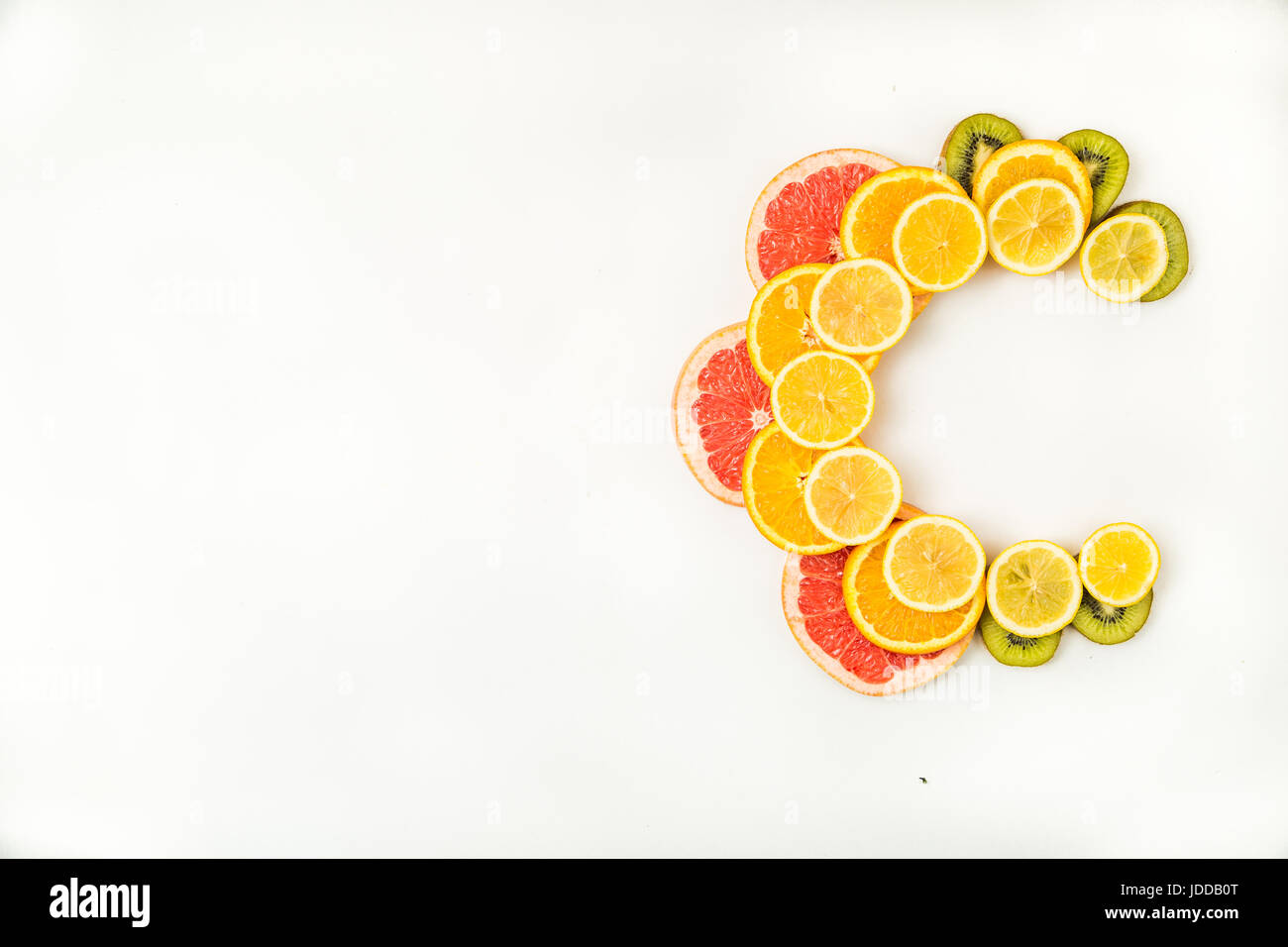 Vitamin C letters made of citrus fruits - lemon, grapefruit, kiwi and ...