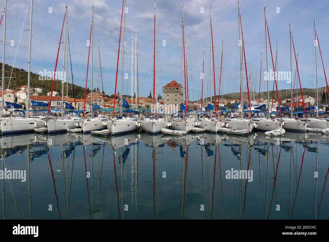 Early morning image of twelve Sunsail yachts reflecting in harbour at ...