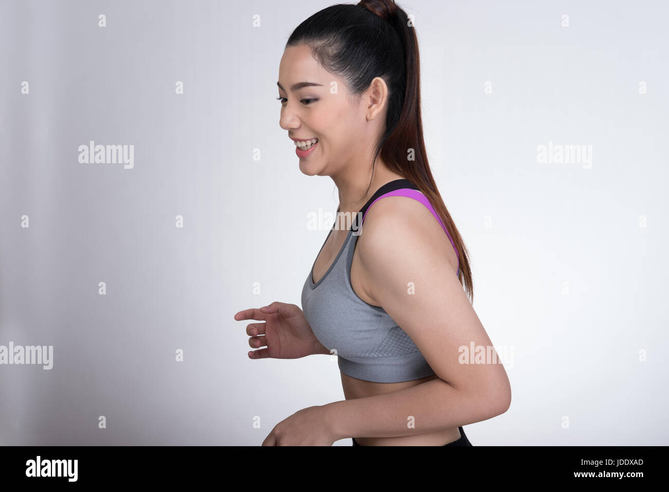 beautiful sporty asian fitness woman standing against white background ...