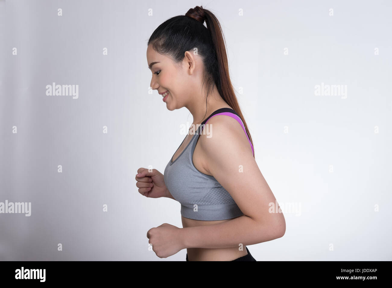 beautiful sporty asian fitness woman standing against white background ...