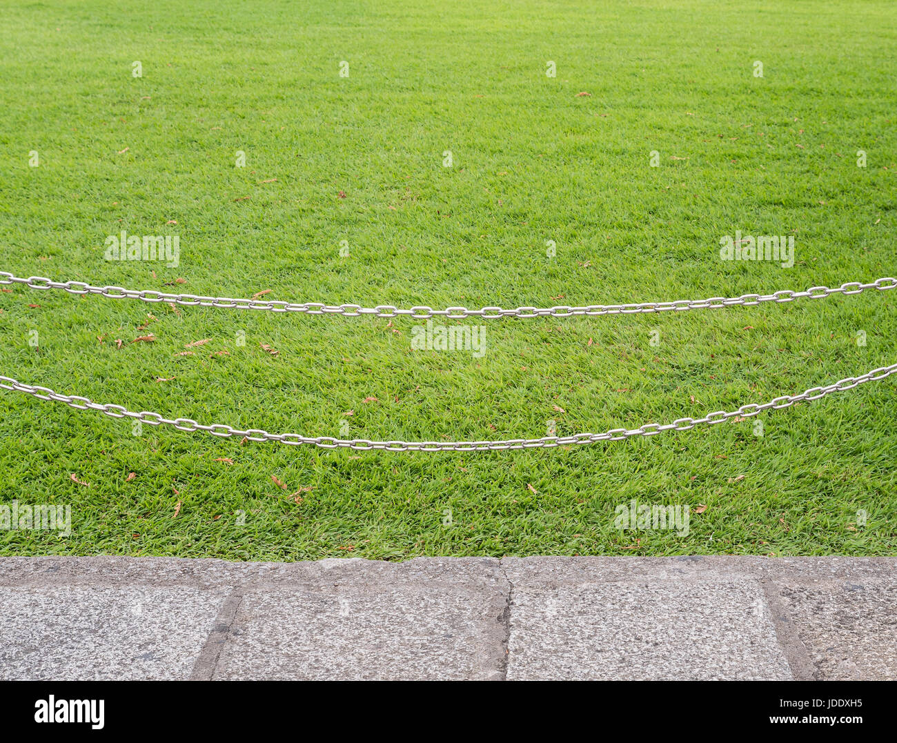 Metal chain of the safety barrier for protection the meadow in the ...