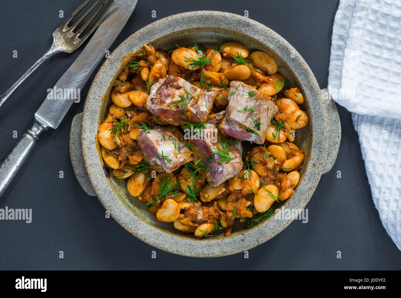 Seared lamb with beans - top view Stock Photo - Alamy