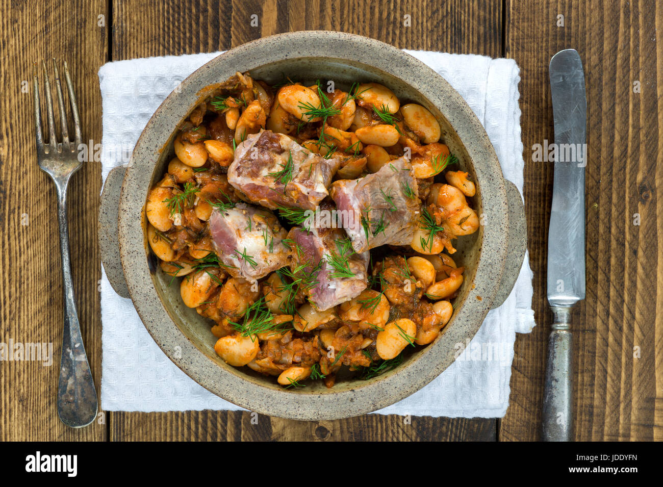 Seared lamb with beans - top view Stock Photo - Alamy