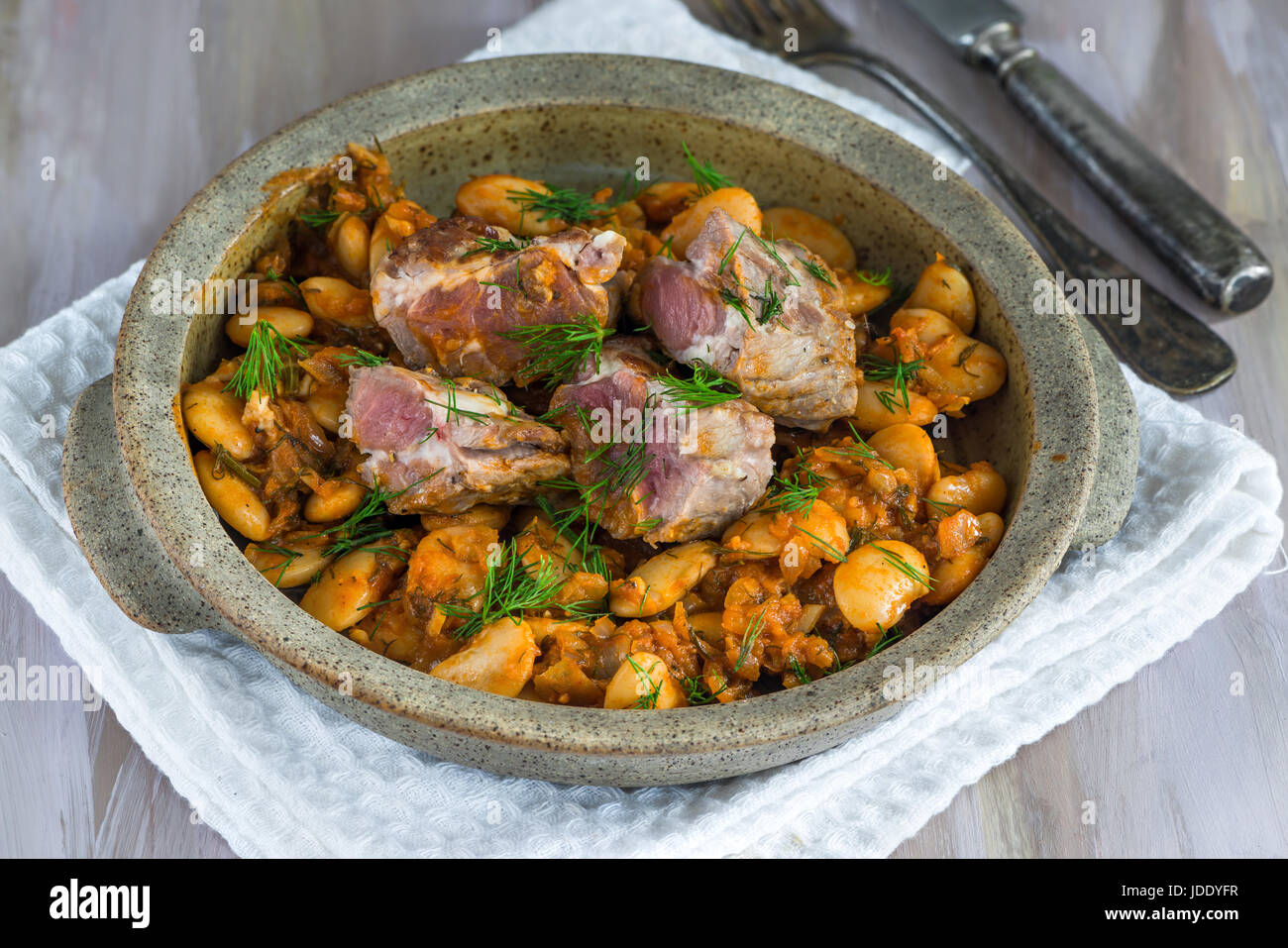 Seared lamb with beans - top view Stock Photo - Alamy