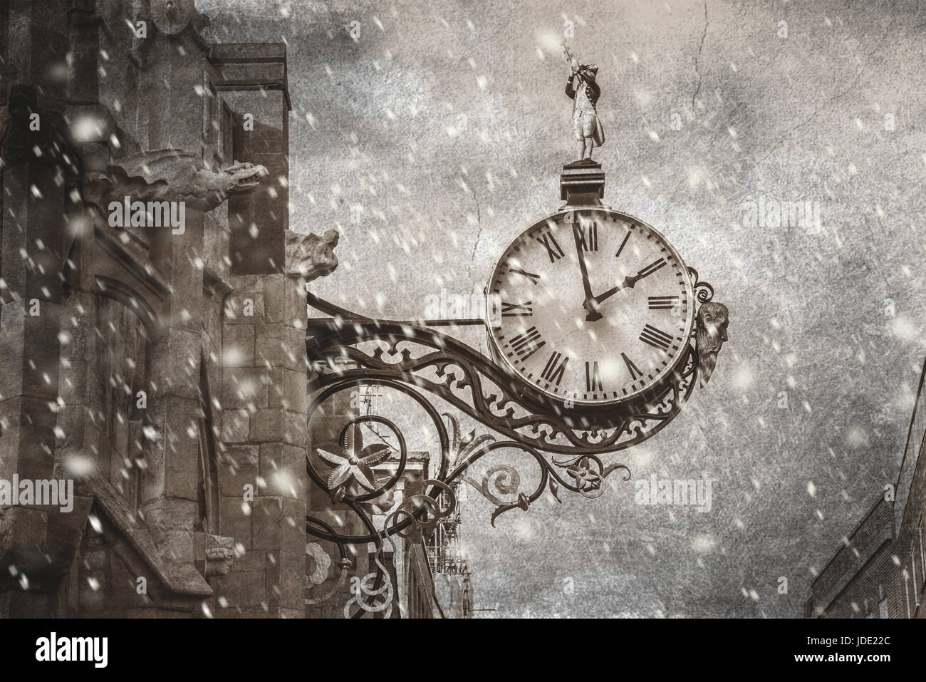 An old vintage clock fixed to wall in snowing time Stock Photo - Alamy