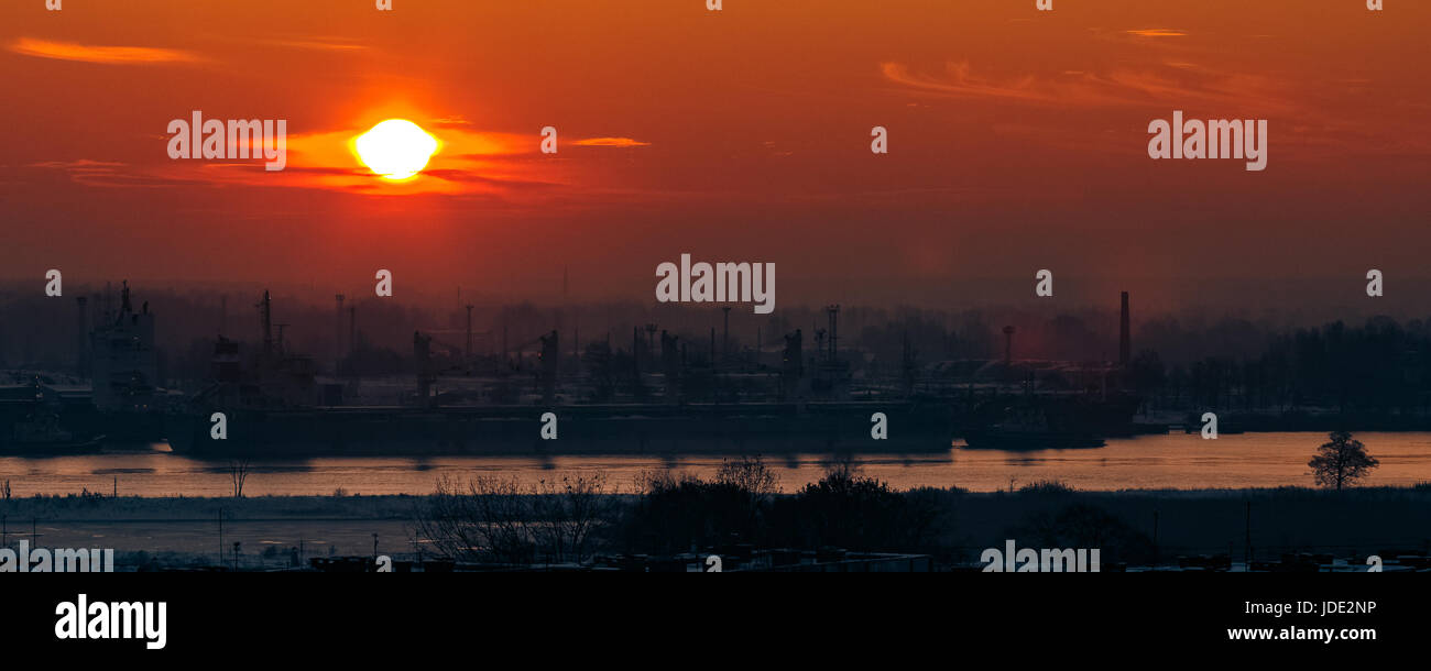 Hot orange sunset over the river. Urban landscape Stock Photo - Alamy