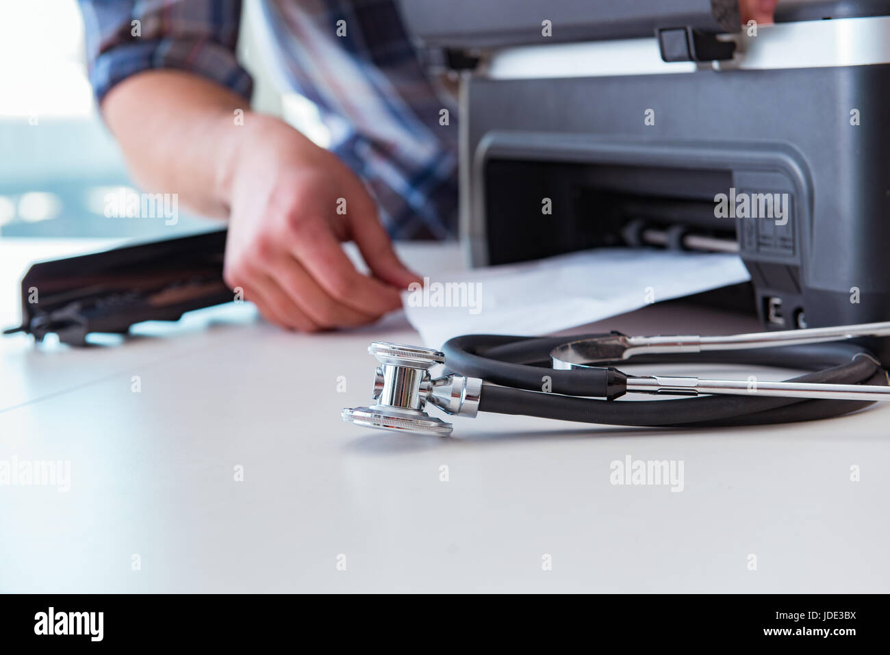 Repairman repairing broken color printer Stock Photo - Alamy