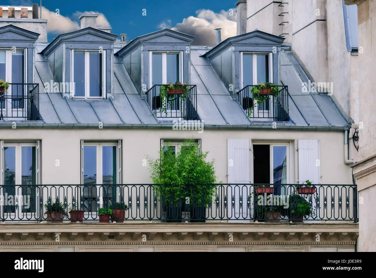 Part of the house in Paris with attic rooms on the roof and a balcony ...