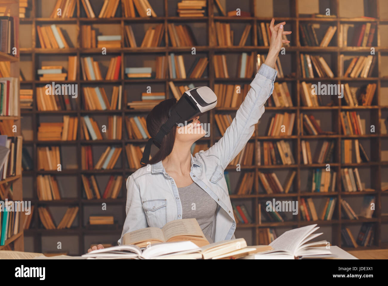 Young female study in the library using virtual reality headset Stock ...