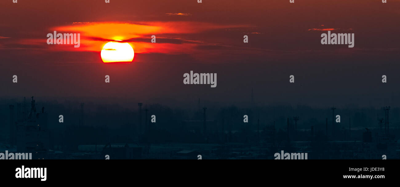 Hot orange sunset over the river. Urban landscape Stock Photo - Alamy