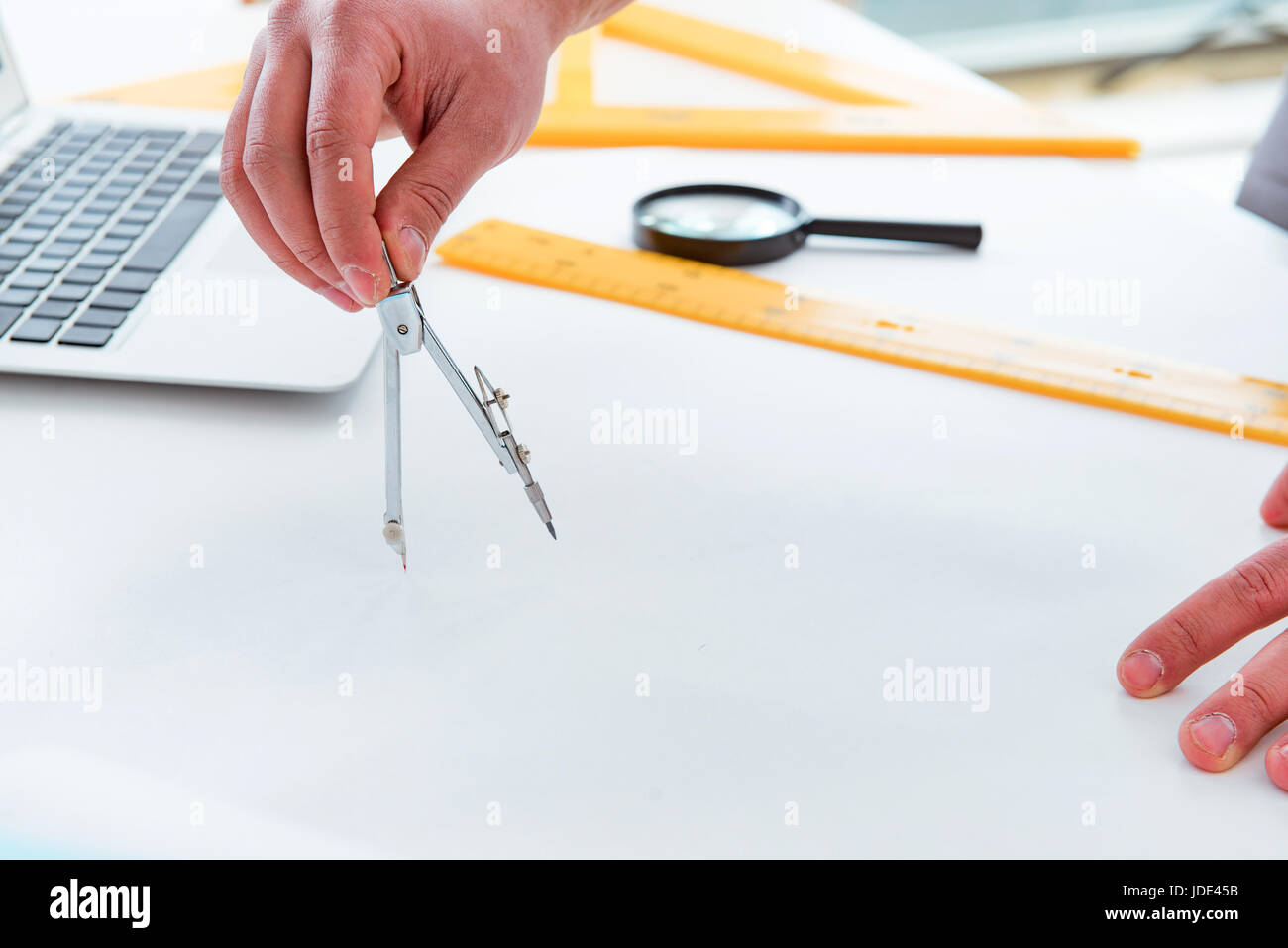 Male engineer working on drawings and blueprints Stock Photo - Alamy