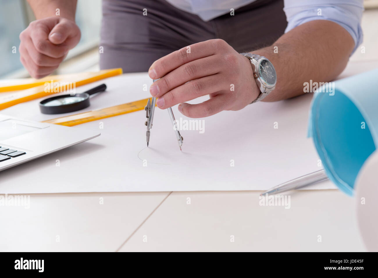 Male engineer working on drawings and blueprints Stock Photo - Alamy