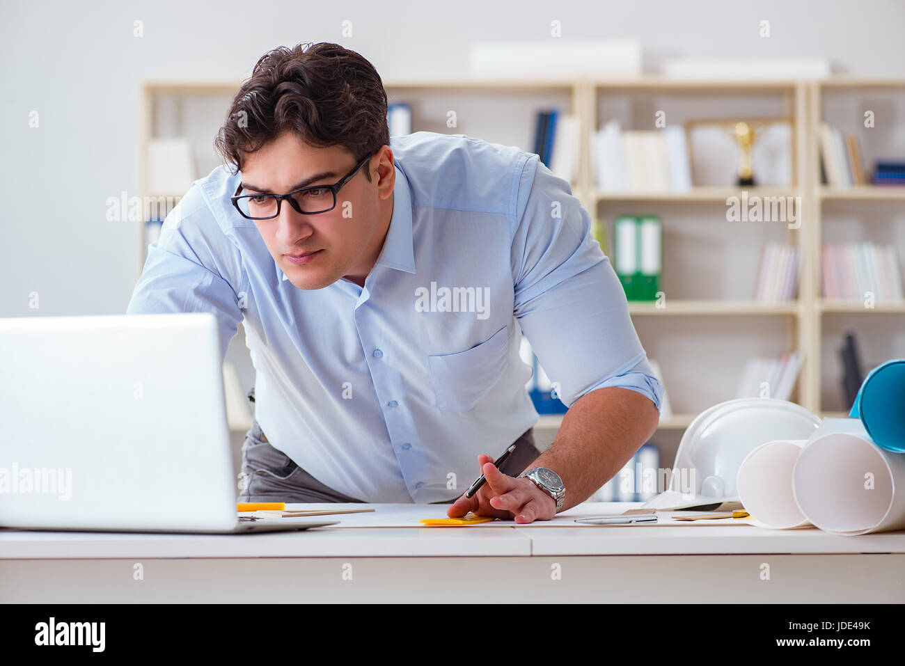 Male engineer working on drawings and blueprints Stock Photo - Alamy