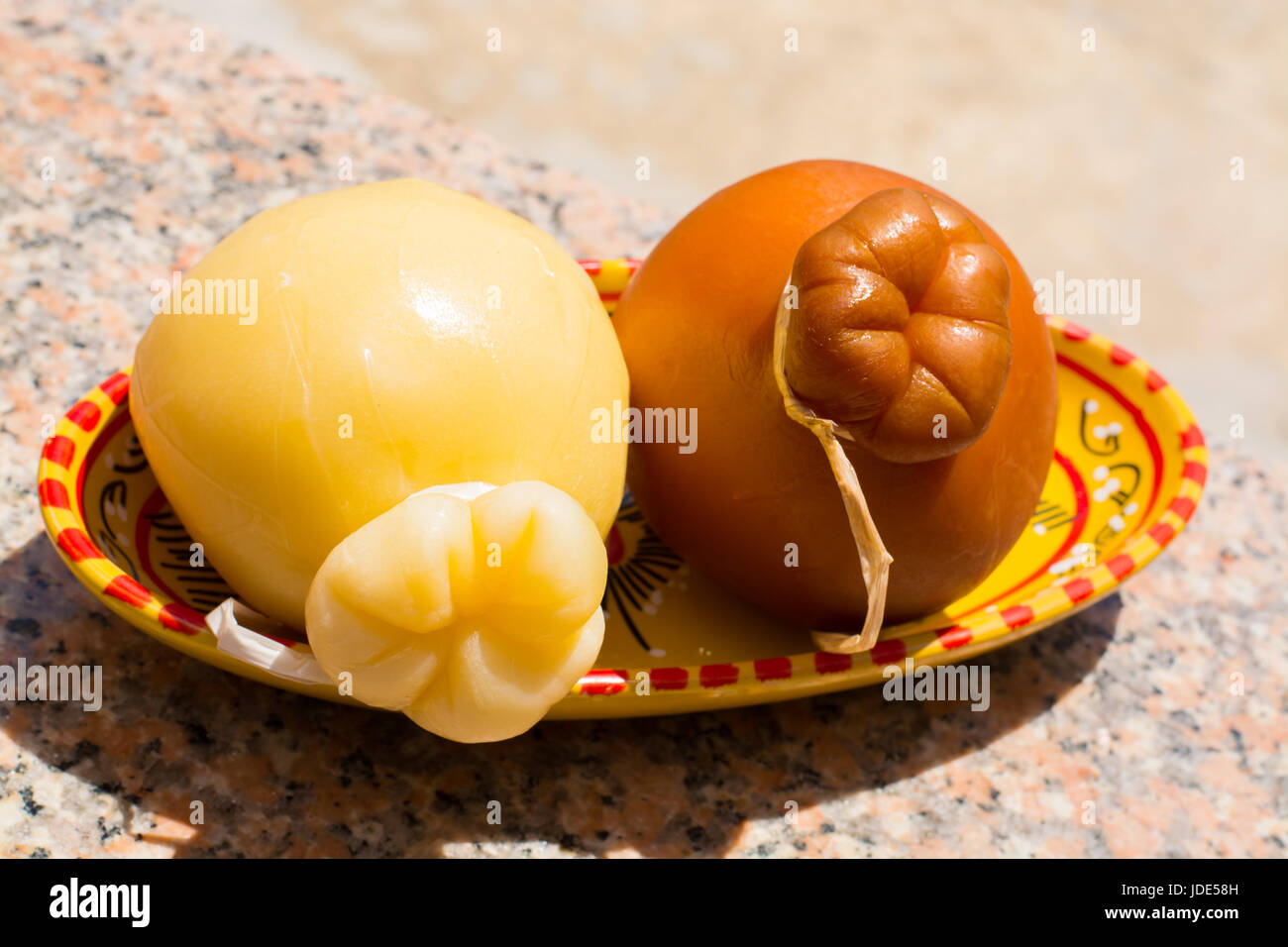 Traditional Italian hard cheese Provolone of Caciocavallo, white and ...