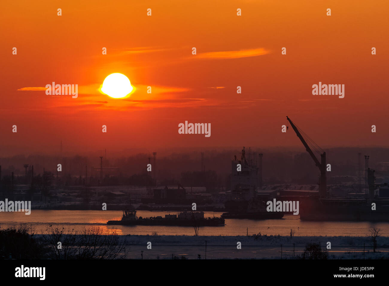 Hot orange sunset over the river. Urban landscape Stock Photo - Alamy