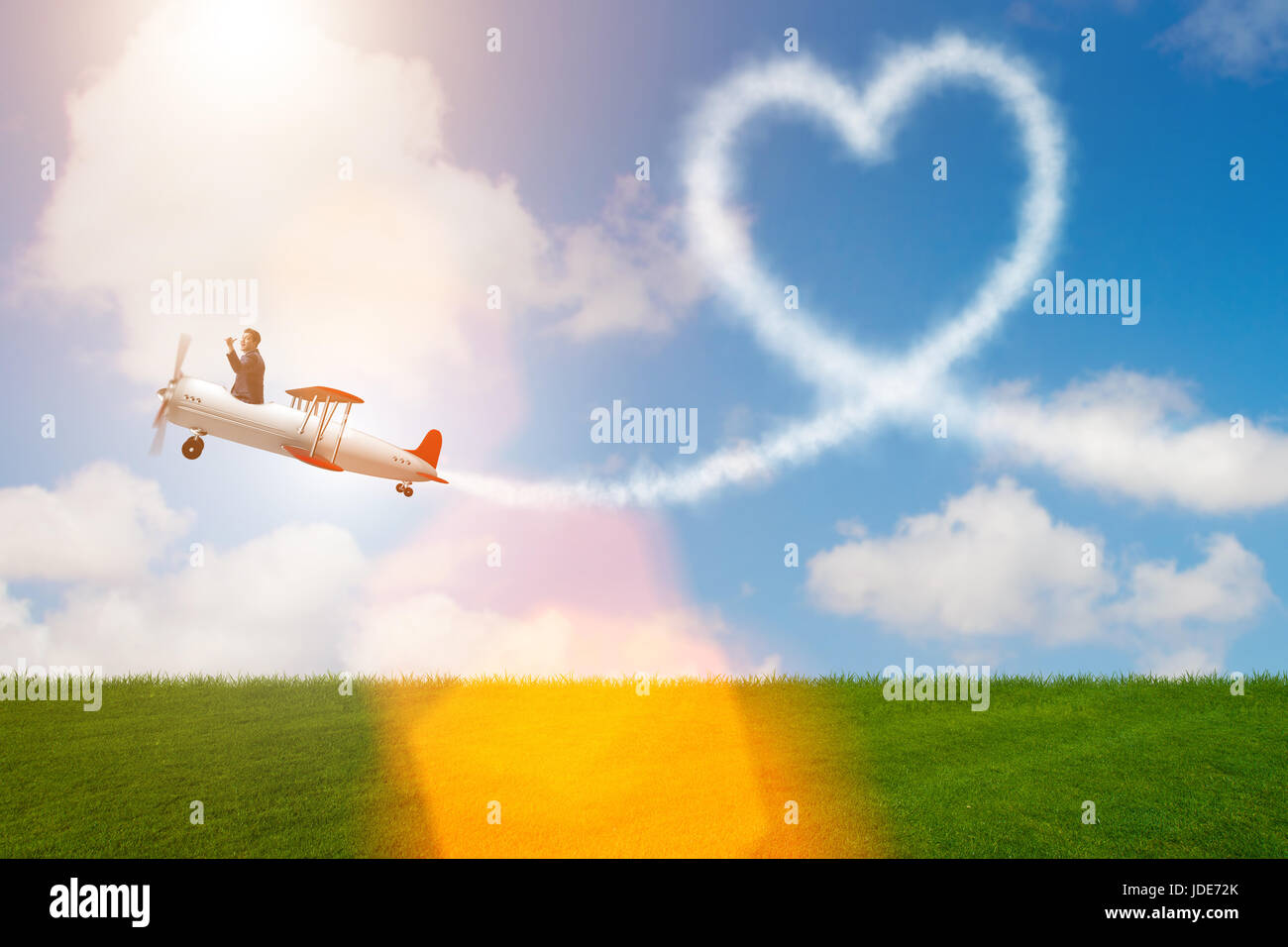 Man flying airplane and making heart shape Stock Photo - Alamy