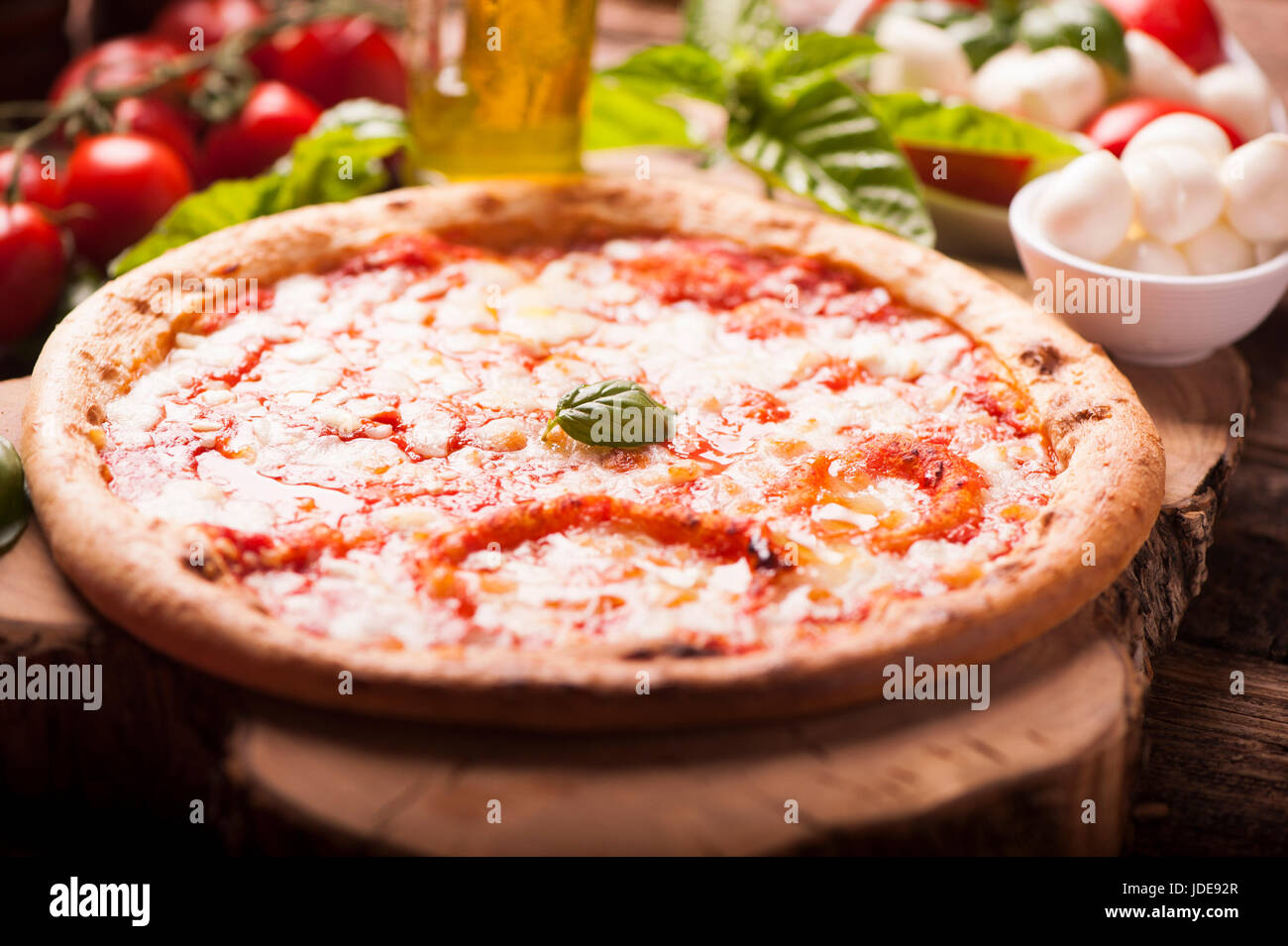 Italian Pizza on rustic wooden table Stock Photo - Alamy