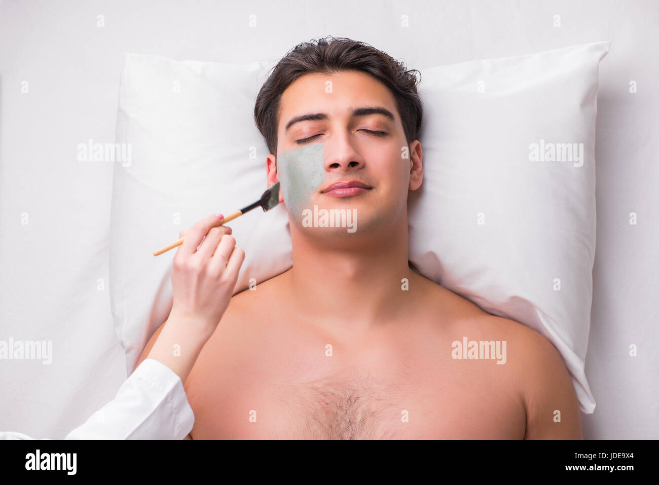 Handsome man in spa massage concept Stock Photo - Alamy