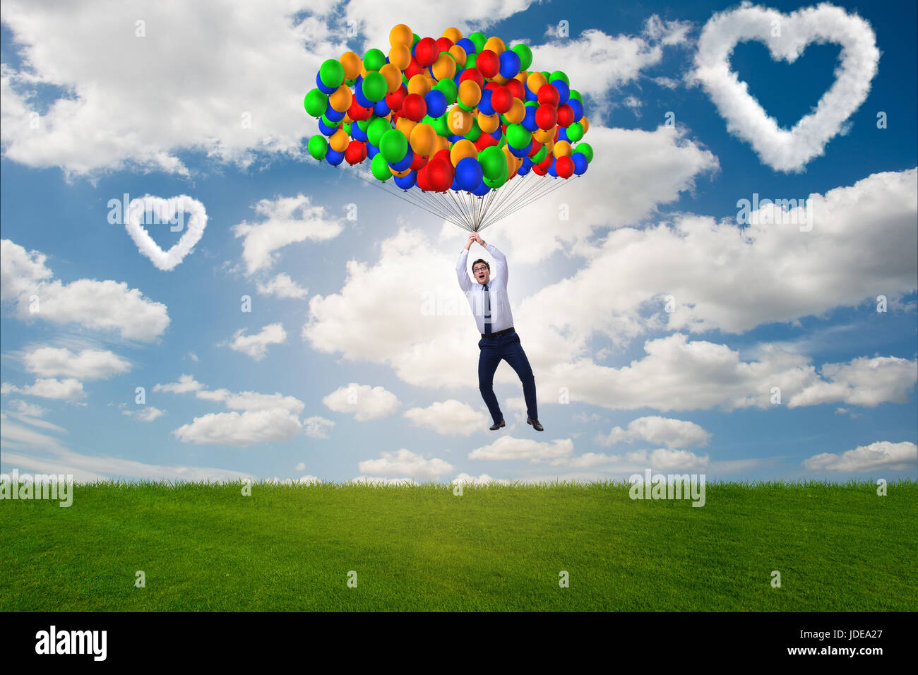 Man flying balloons in romantic concept Stock Photo - Alamy