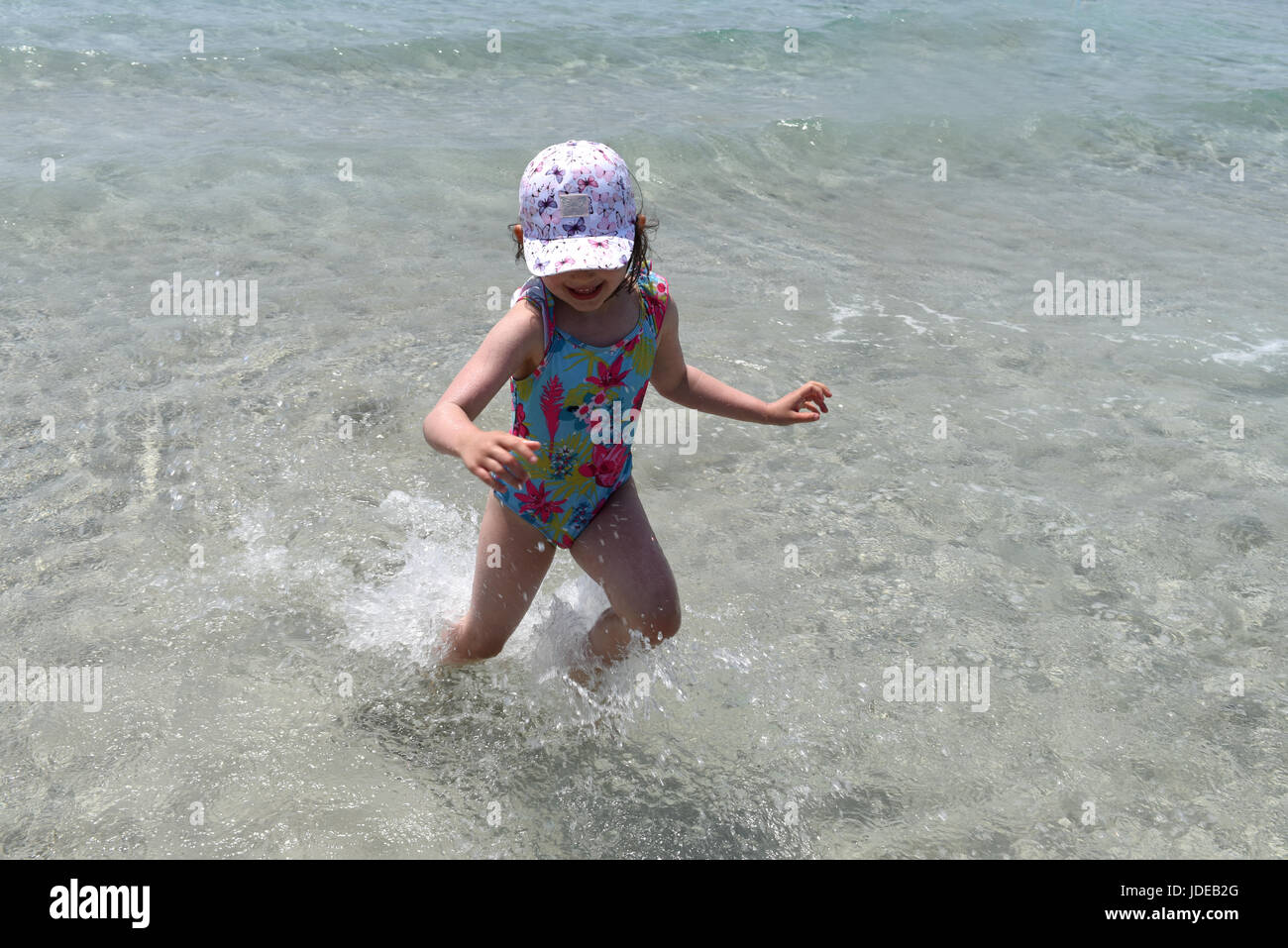 Children playing in the waves hi-res stock photography and images - Alamy