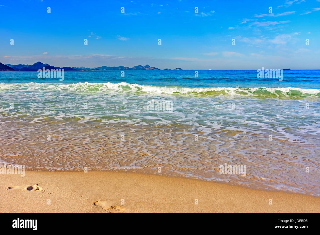Water over sand in Cpacabana beach horizon with Rio de Janeiro hills ...