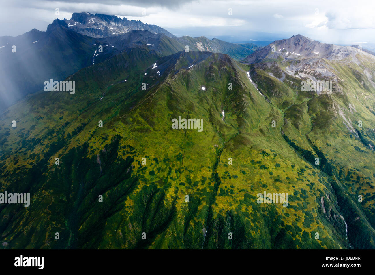Rain storm moves over a green mountain landscape in Alaska Stock Photo ...