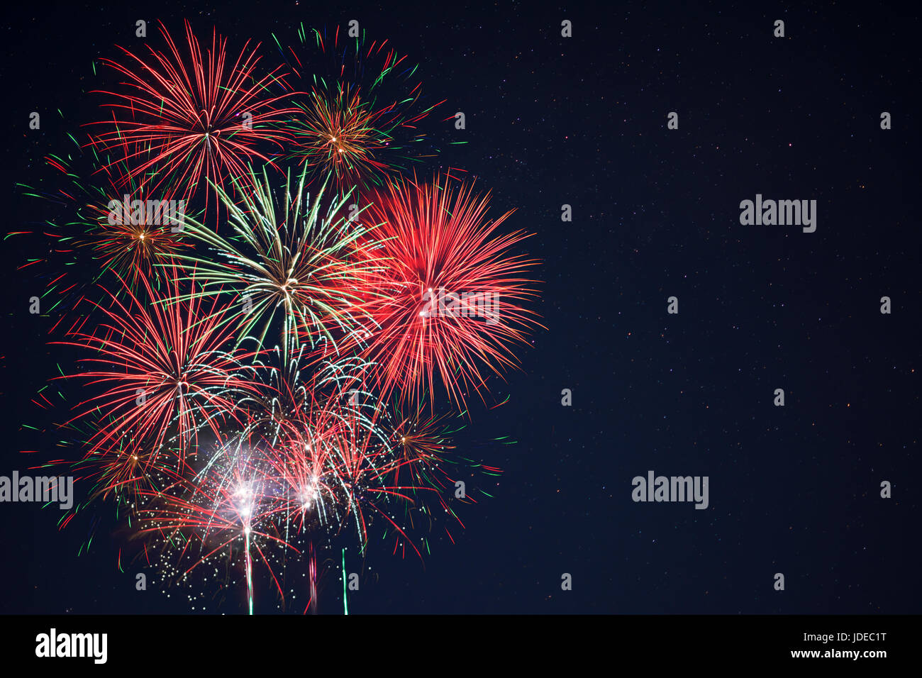 Beautiful red green yellow celebration fireworks located left side over ...