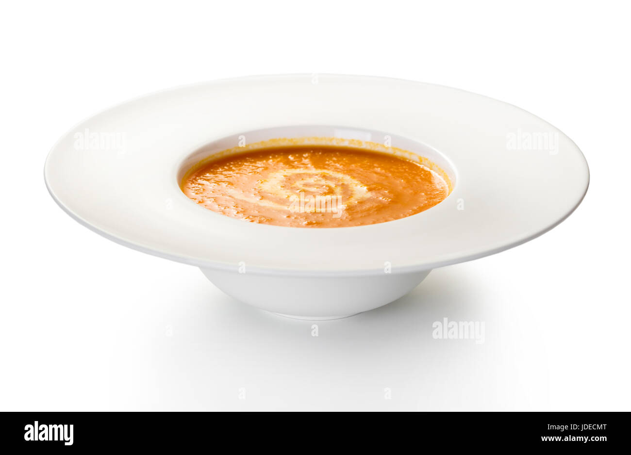 Carrot cream soup puree on white background Stock Photo - Alamy