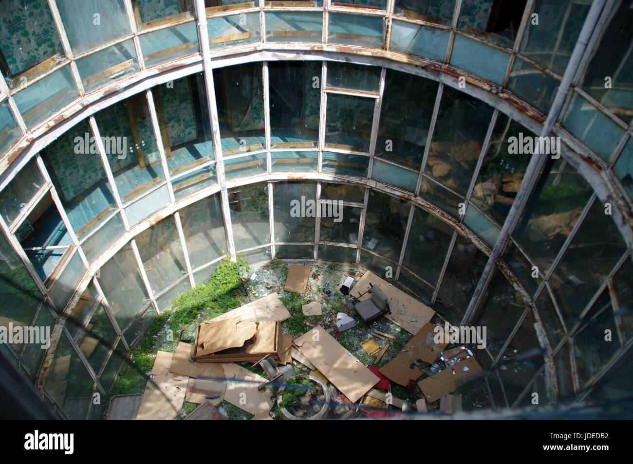 Forgotten round building with shattered glass. Broken windows pane ...