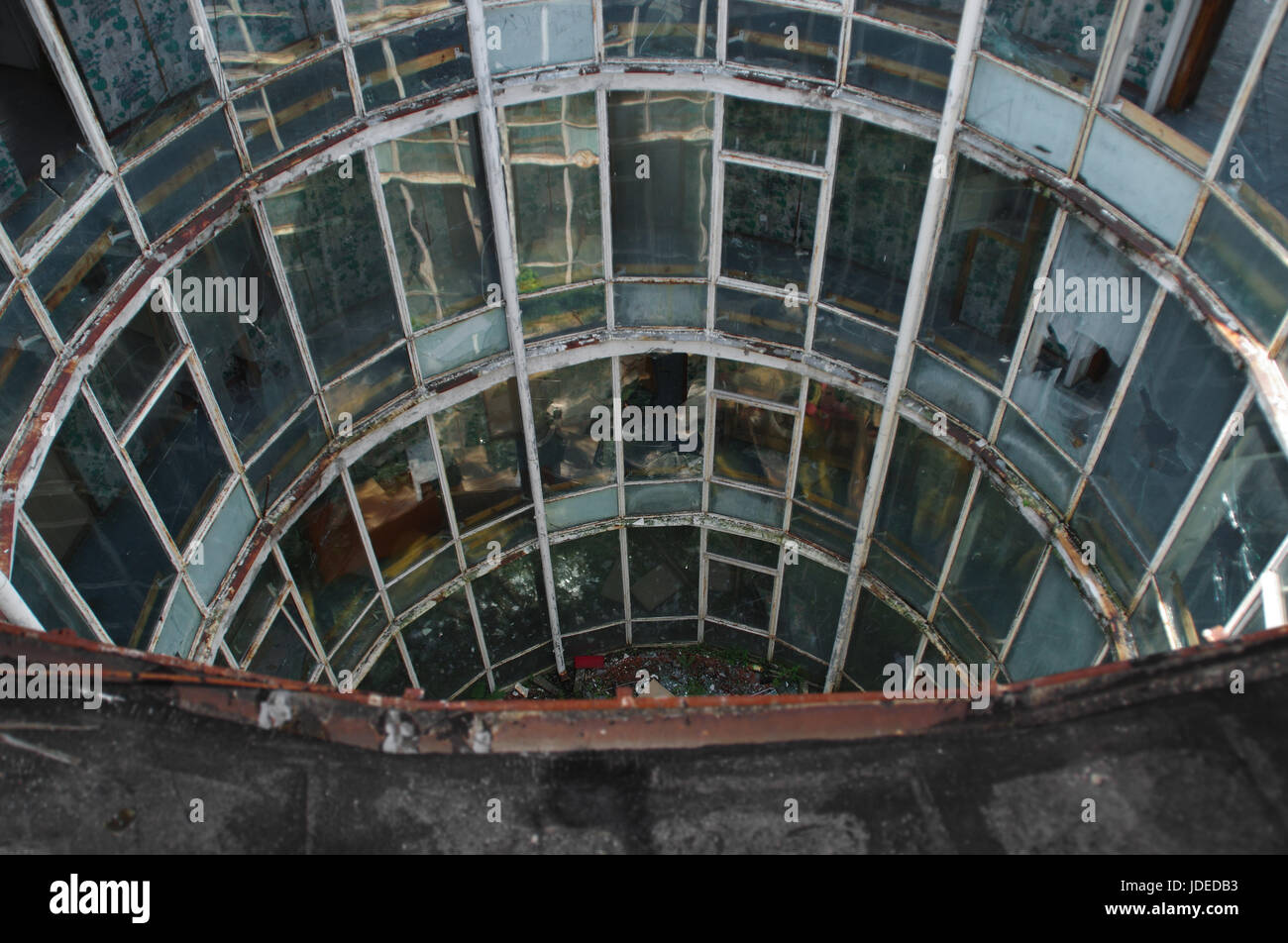 Forgotten round building with shattered glass. Broken windows pane ...