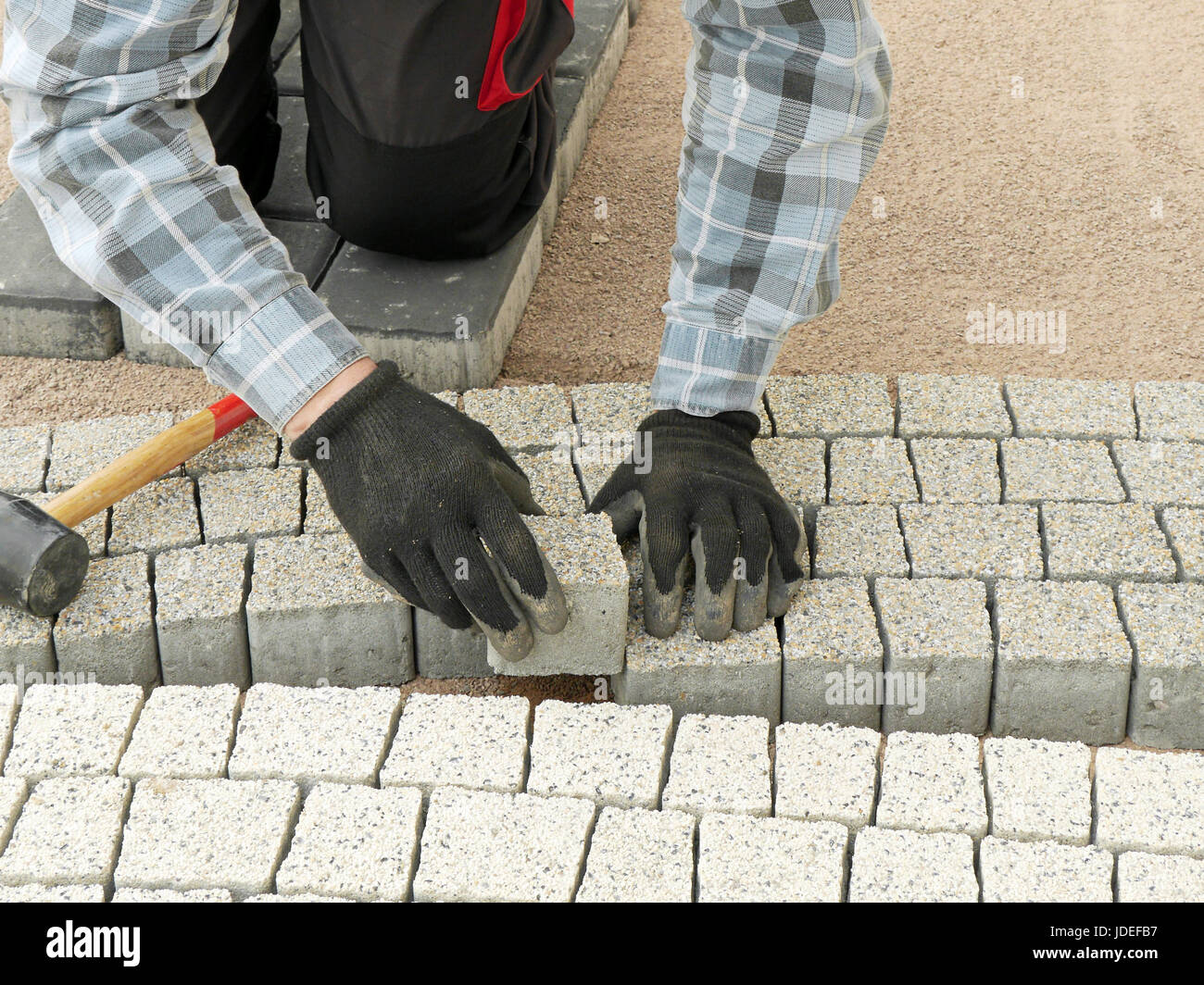 Paver laying pathway out of concrete pavement blocks Stock Photo - Alamy