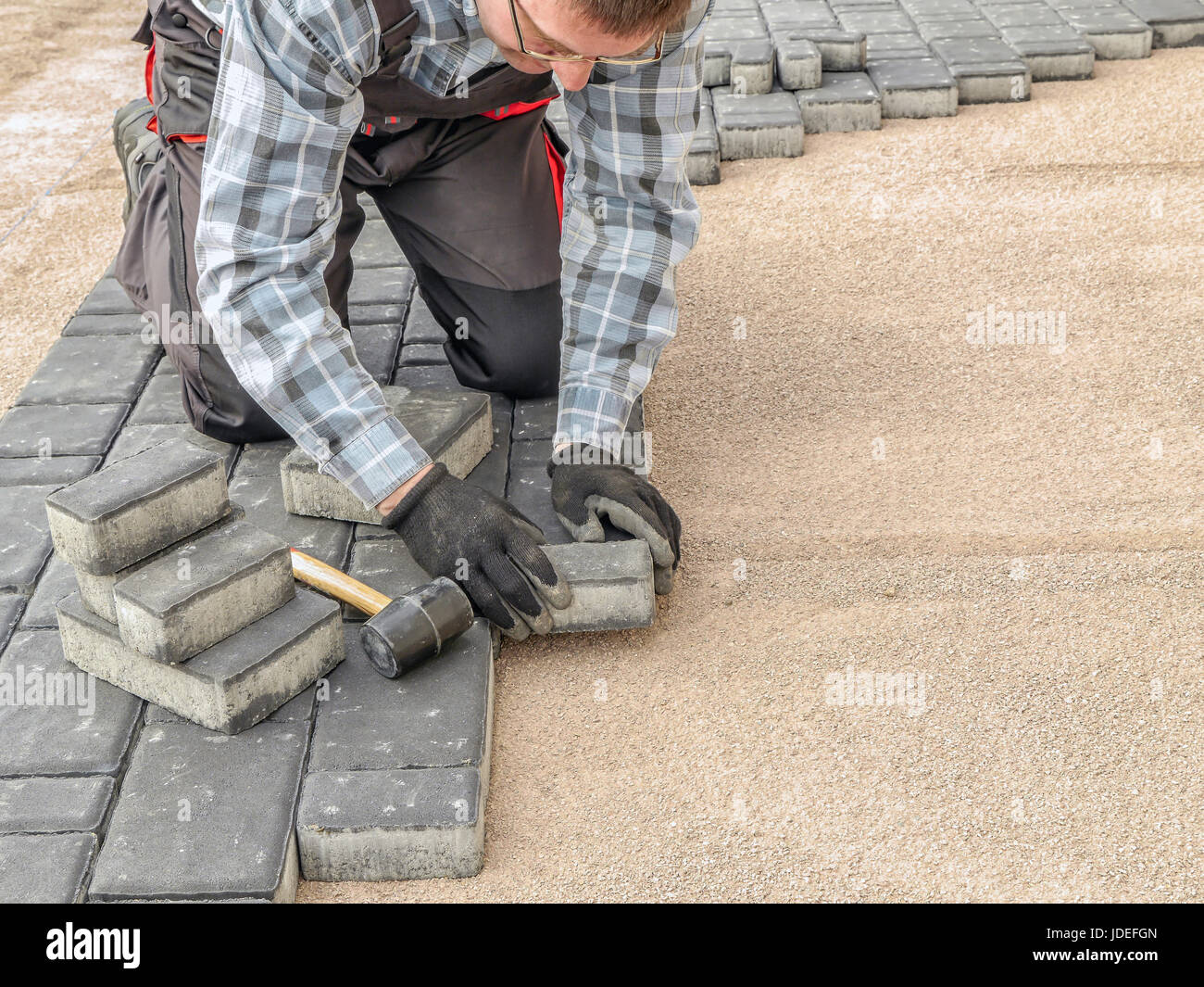 Paver laying driveway pavement out of concrete pavement blocks Stock ...
