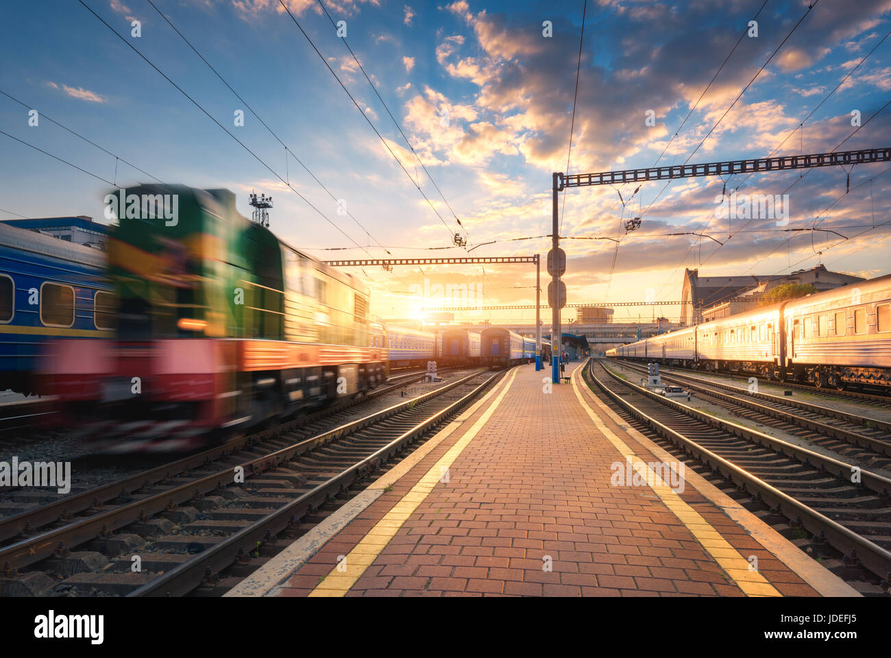 Amazing industrial view with old locomotive in motion, passenger trains ...